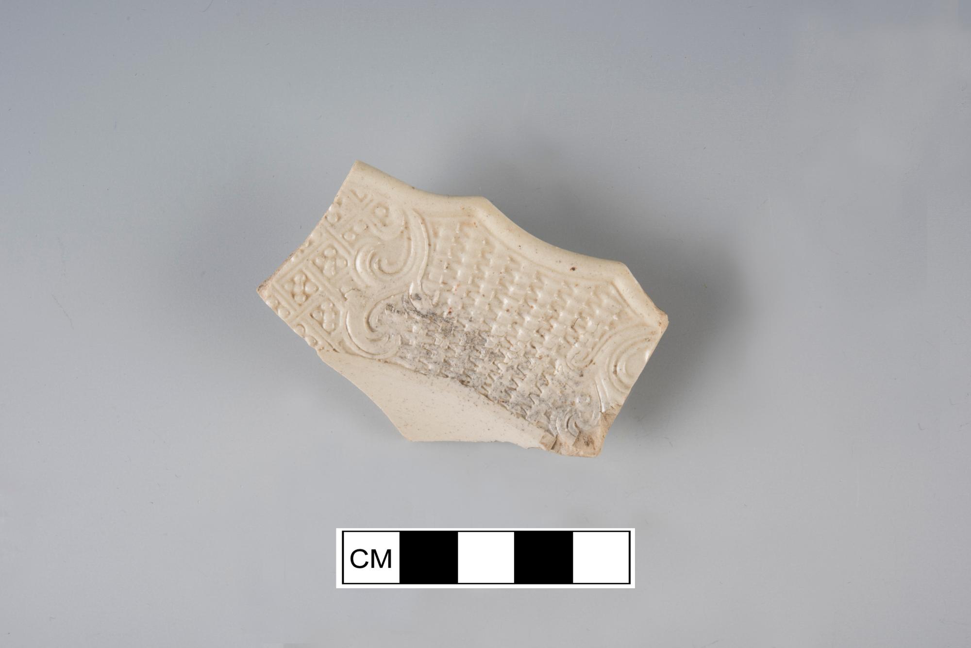 White salt glaze stoneware dot, diaper, and basket molded plate ...